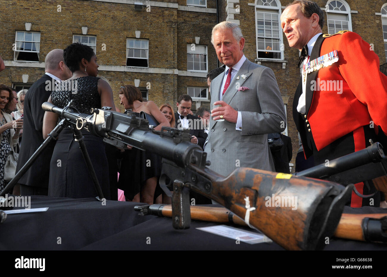 The Prince of Wales looks at a display of weapons with Lieutenant ...