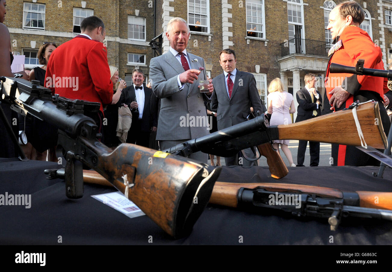 The Prince of Wales looks at a display of weapons with Lieutenant ...