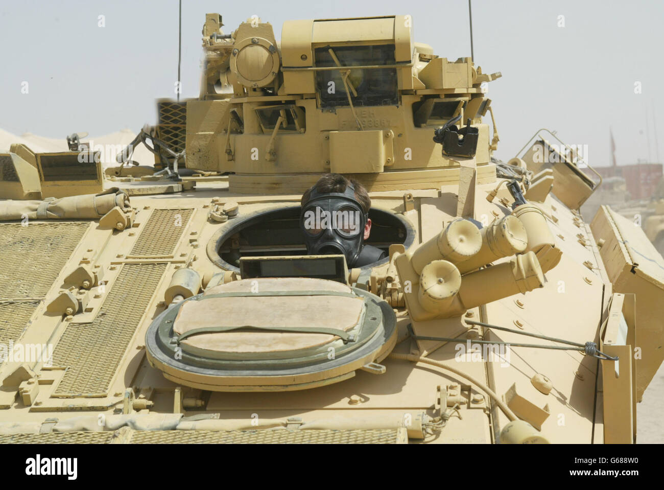 A driver in a Spartan tank wearing a gas mask during NBC drills at Camp ...