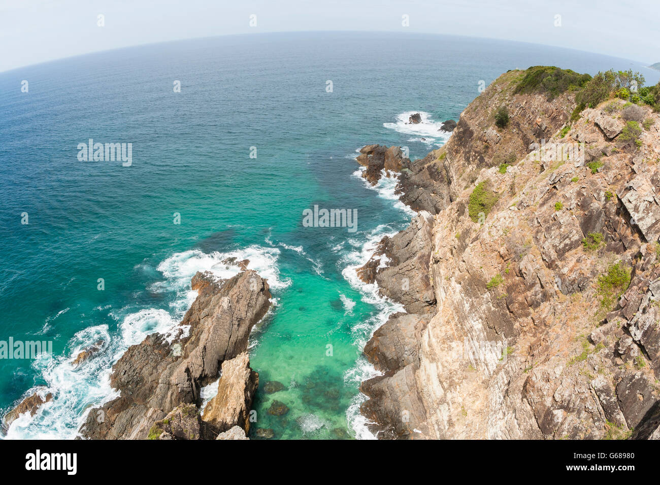 Ocean blue horizon overlooking rocky cliffs landscape Stock Photo - Alamy