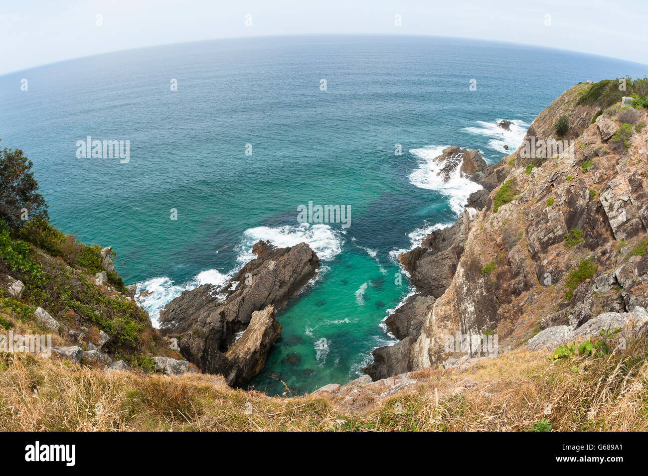 Ocean blue horizon overlooking rocky cliffs landscape Stock Photo - Alamy