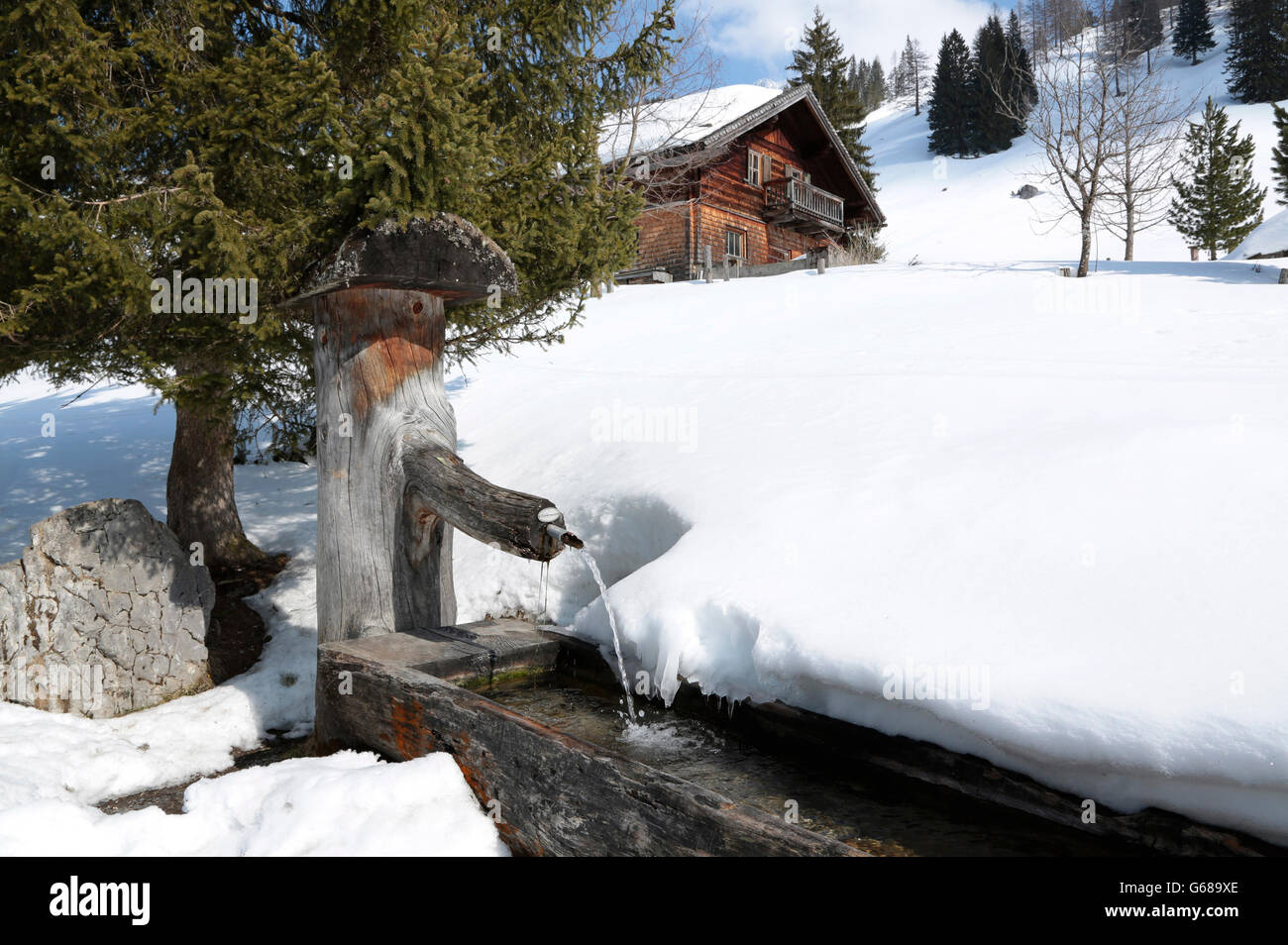 Water tap in a wooden stump in Filzmoos, Austria Stock Photo - Alamy