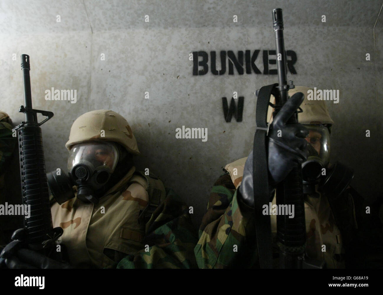 U.S. troops wait in full nuclear biological and chemical protection ...