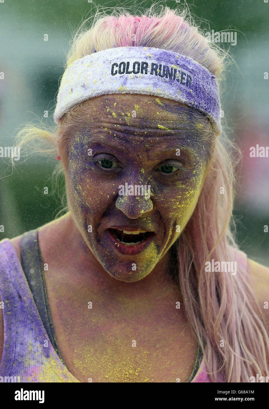 A runner is covered in paint as she takes part in the 5k Colour Run ...