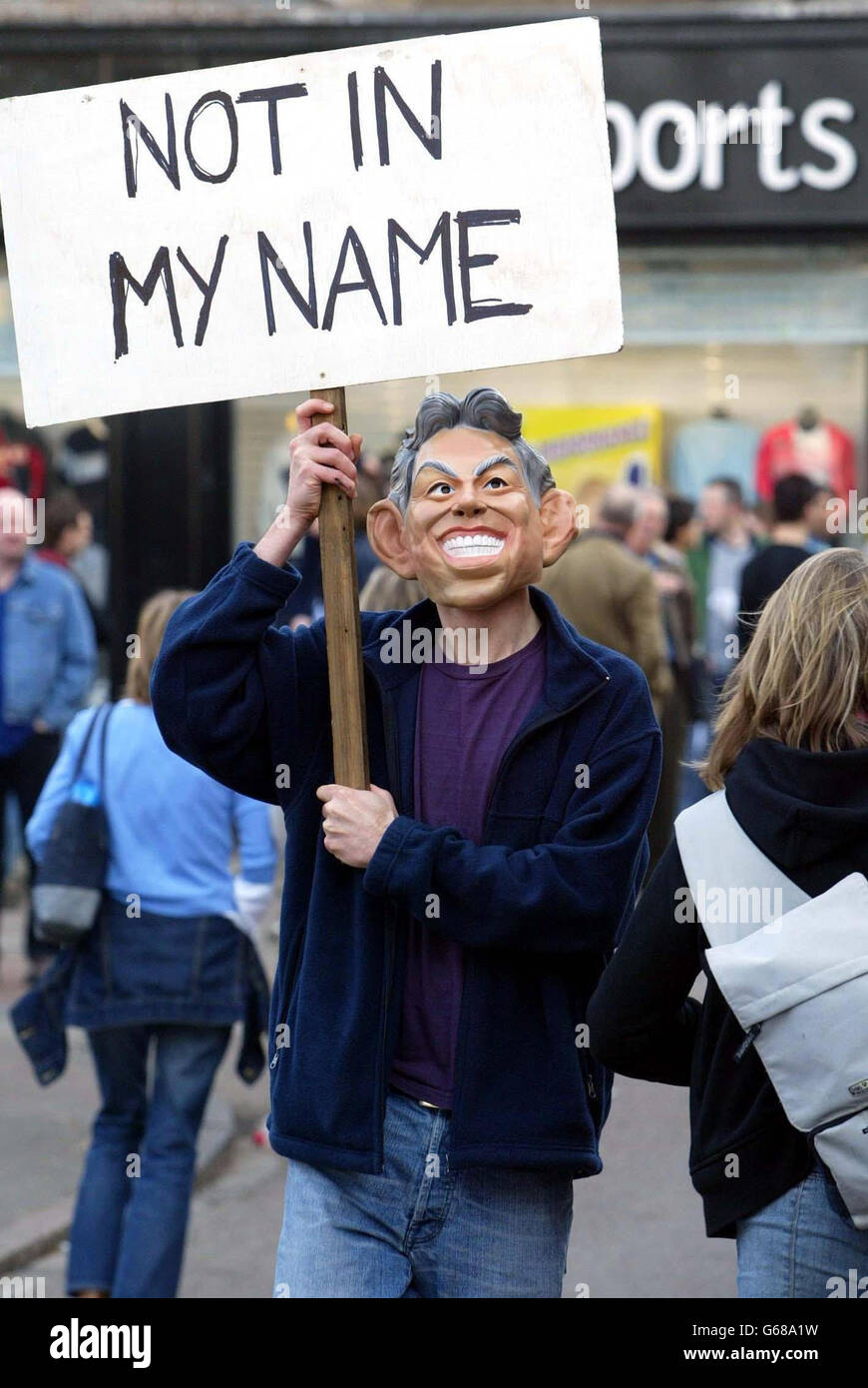 A protester wears a mask of British Prime Minister Tony Blair during a ...