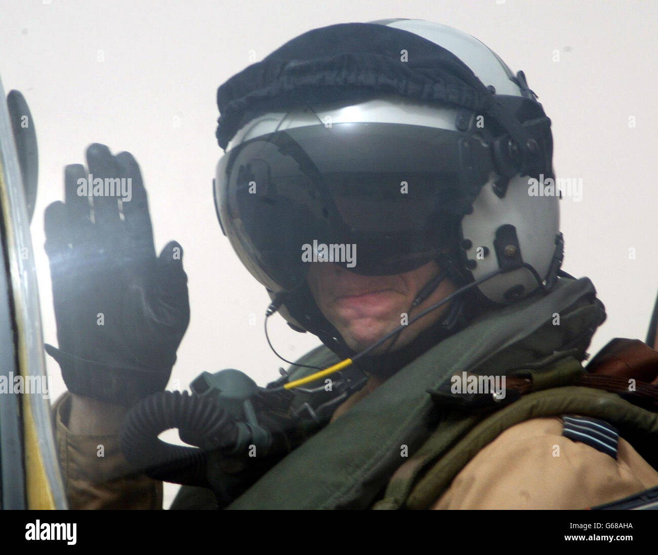 A British Harrier GR7 pilot waves as he taxis to the runway before a ...