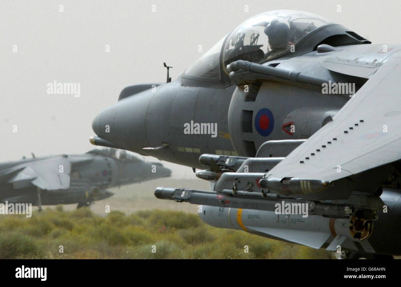 Two British Harrier GR7 taxi in their base in Kuwait to the runway at ...