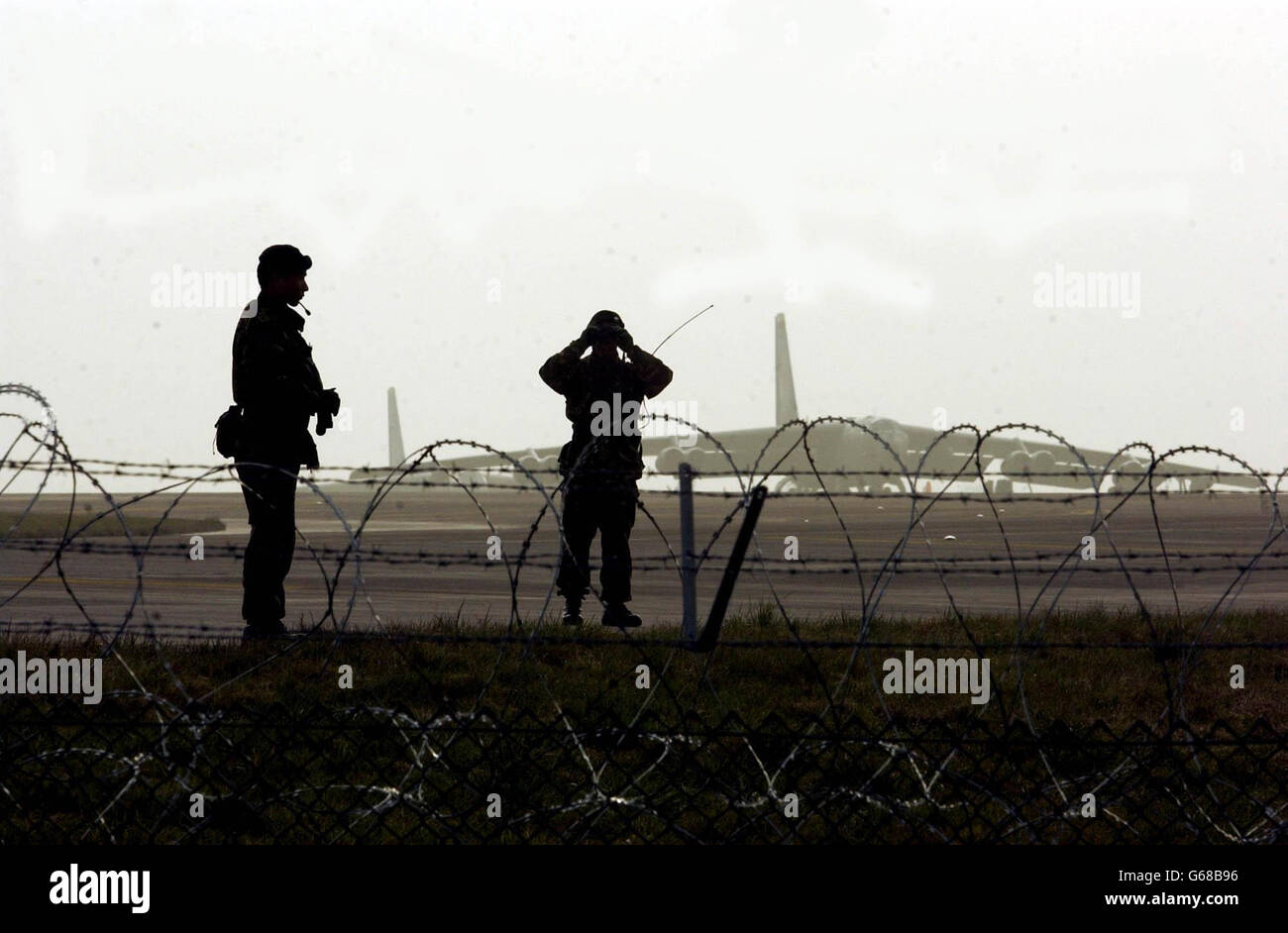 Soldiers from the Royal Gurkha Rifles patrol the perimeter fence at RAF ...