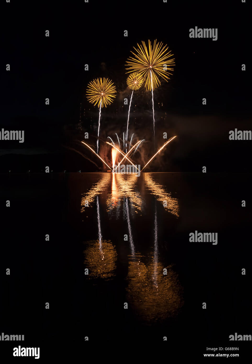 Colorful fireworks with reflection on lake and night sky in background ...
