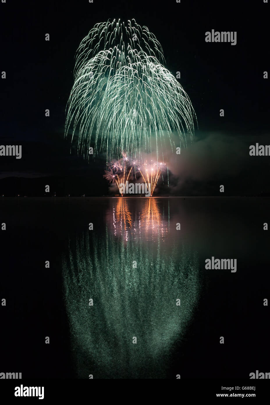 Colorful fireworks with reflection on lake and night sky in background ...