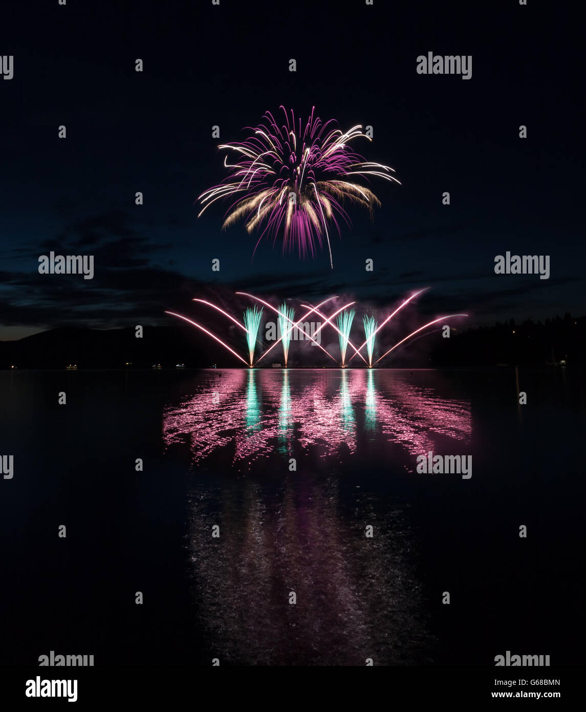 Colorful fireworks with reflection on lake and night sky in background ...