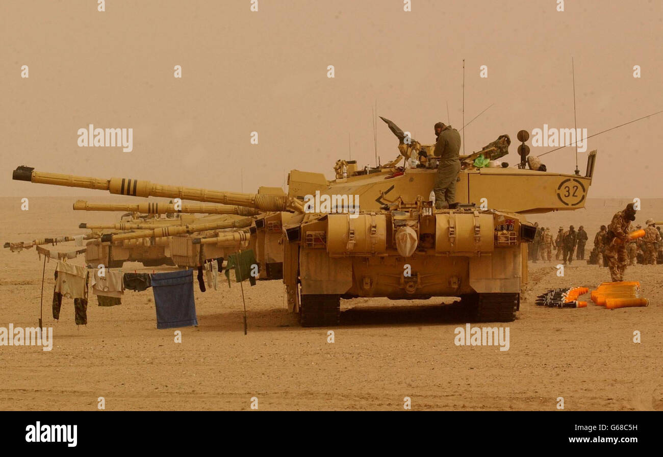 Soldiers from the Royal Scots Dragoon Guards load up their tanks with ...