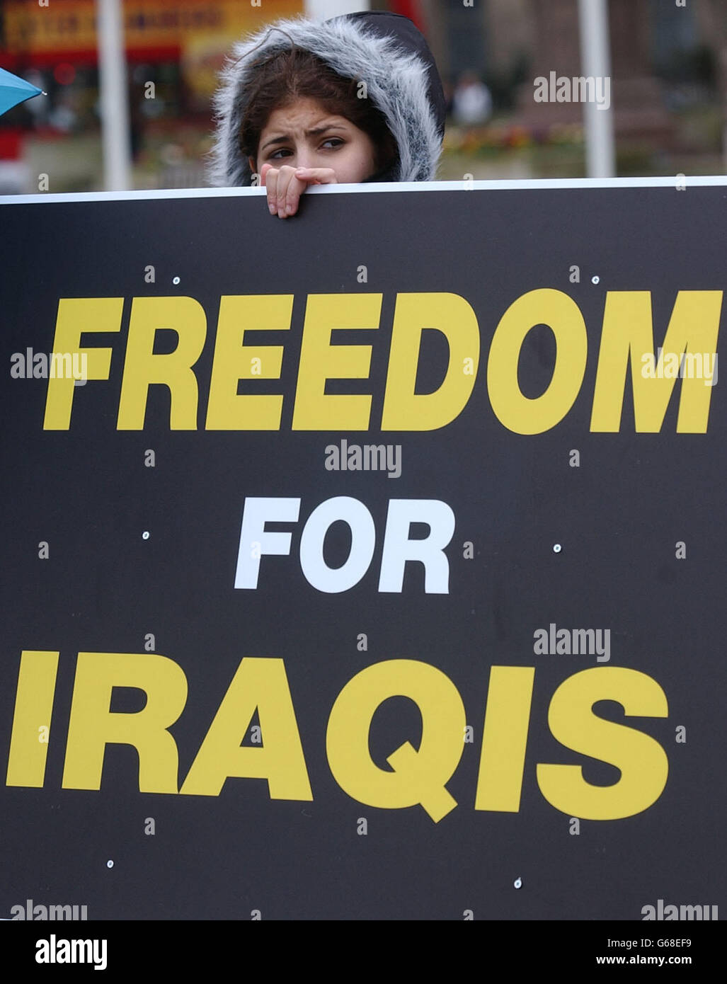 A pro-war campaigner in London's Parliament Square shows her support ...