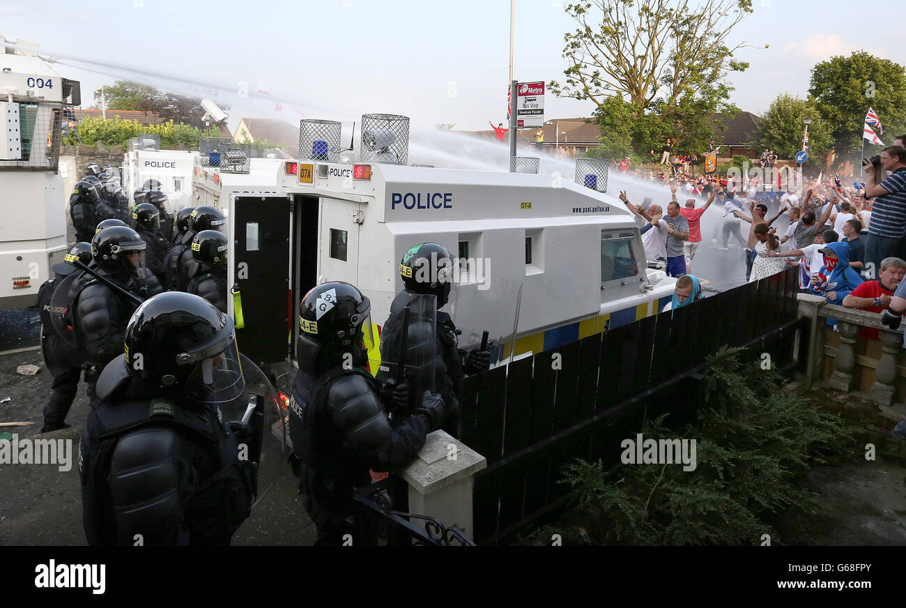 Police Service of Northern Ireland (PSNI) officers, use a water canon ...