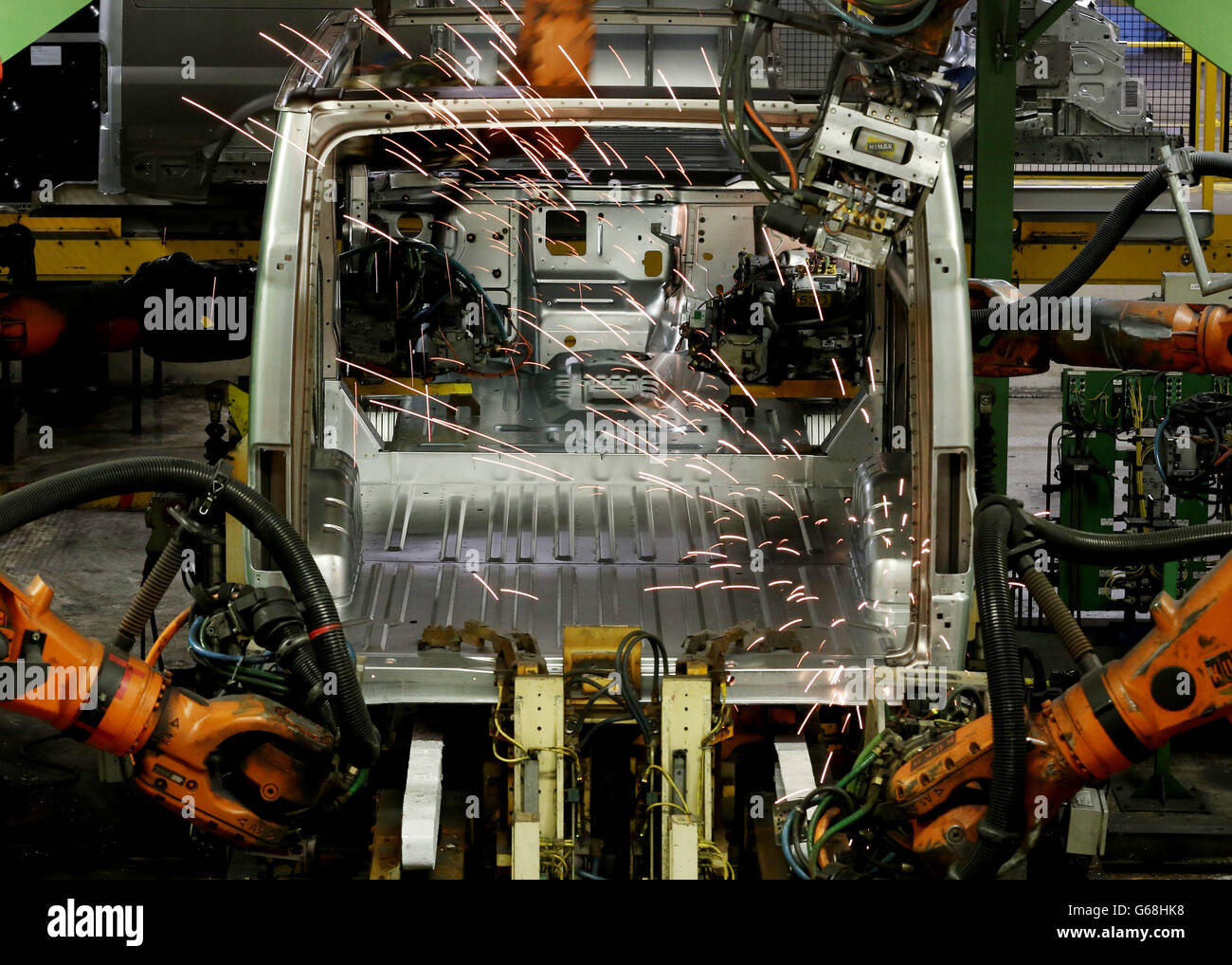 A Ford Transit van is welded together by robots on the production line ...