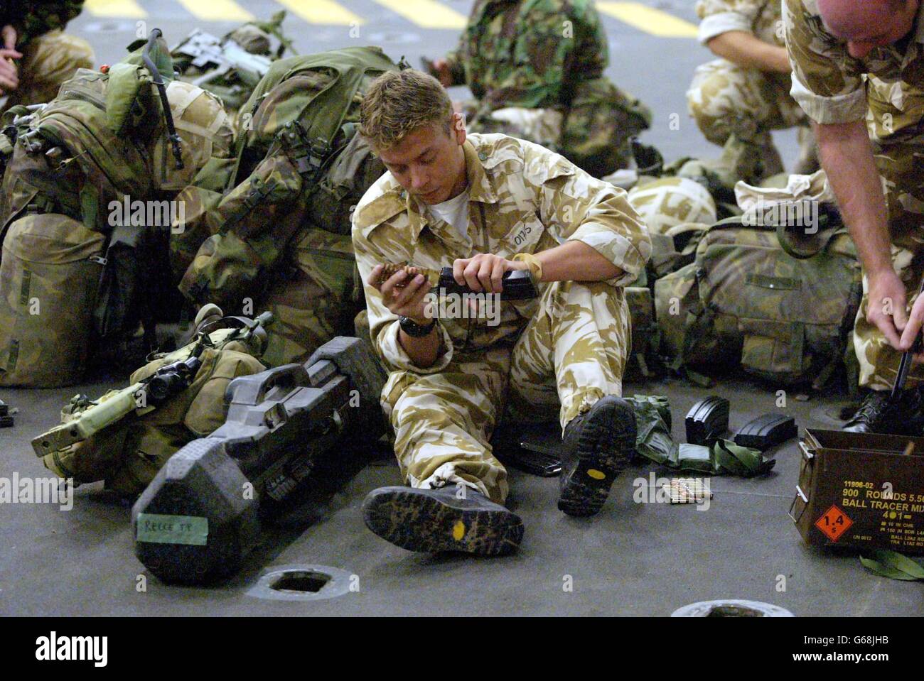 Picture issued, of Royal Marines from 40 Commando from HMS Ocean being issued their ammunition ...