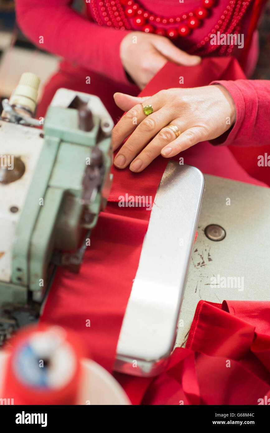 Hand of a seamstress working on a sewing machine Stock Photo - Alamy