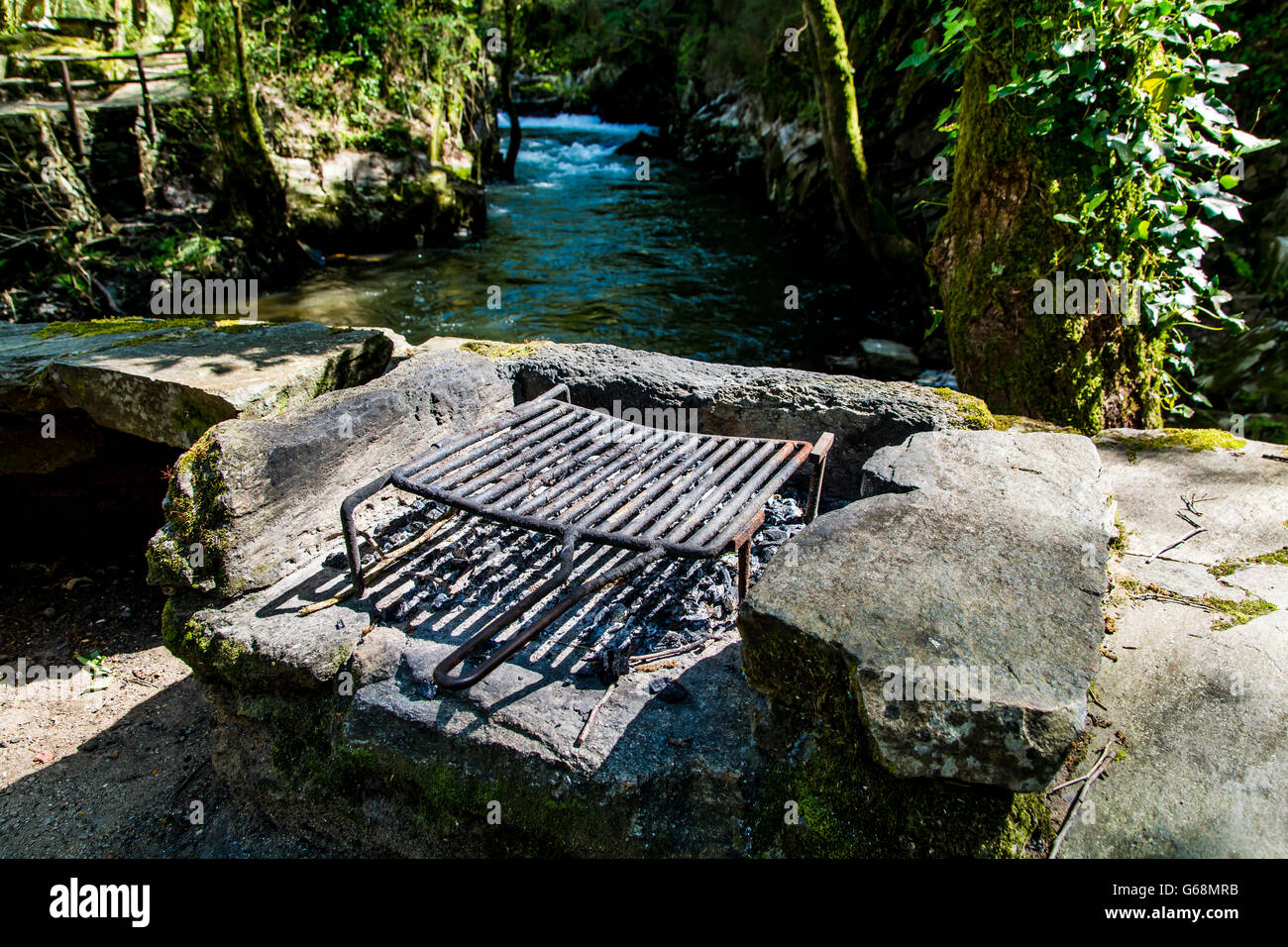 Front View of Used Barbecue Against River and Forest Stock Photo - Alamy