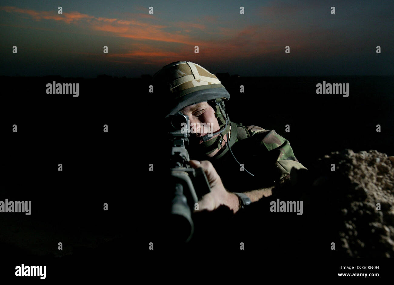 An Irish Guard guards the perimeter of a camp in the Kuwaiti desert ...