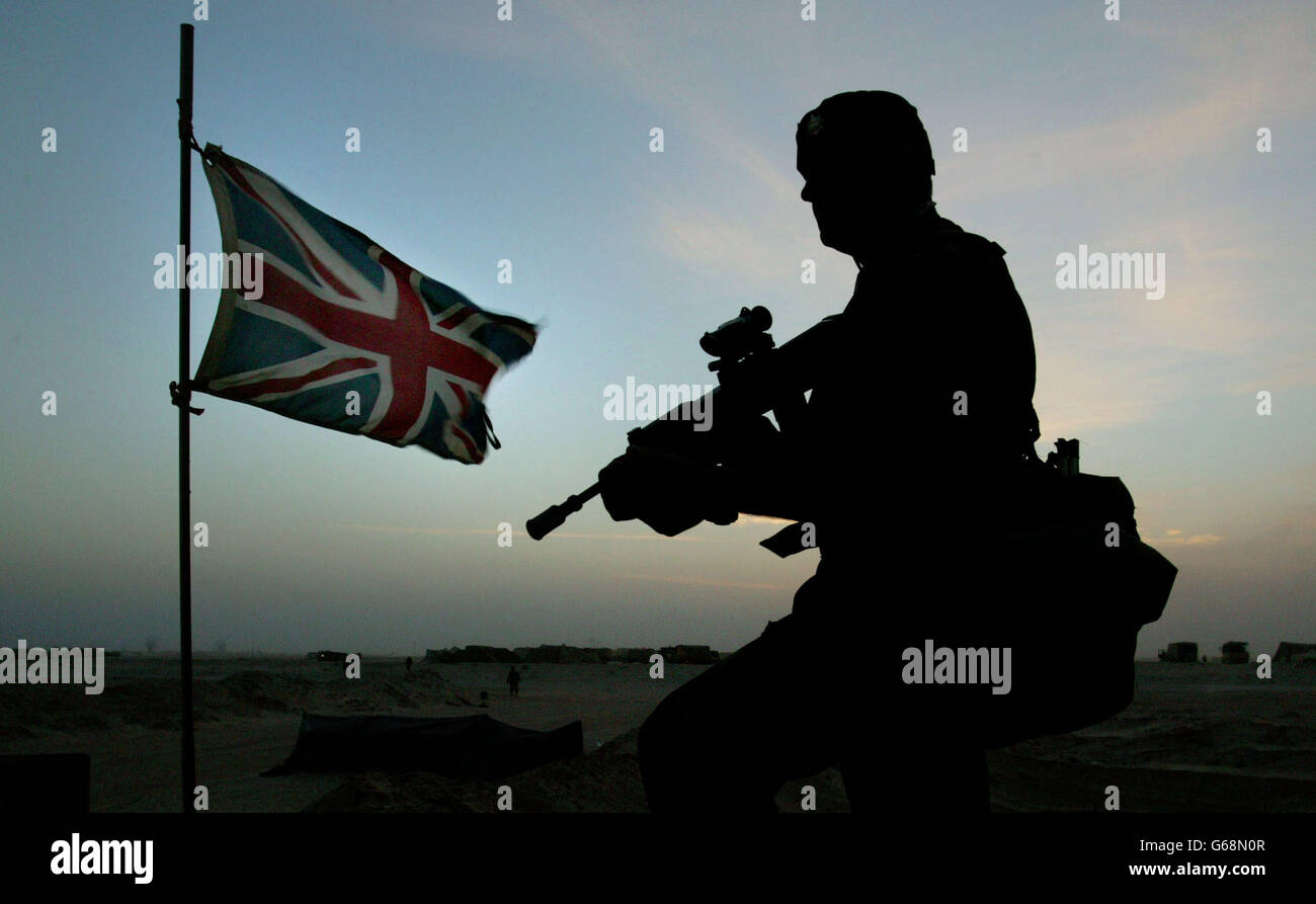 An Irish Guard guards the perimeter of a camp in the Kuwaiti desert ...