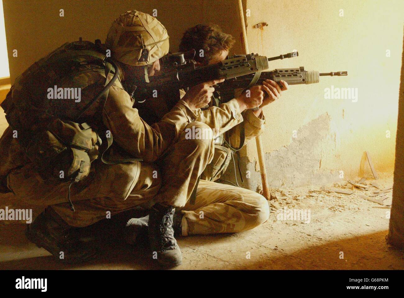 Men from 40 Commando Royal Marines take positions in a building as they ...