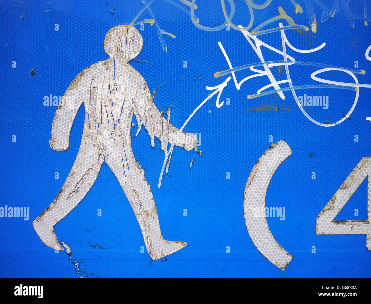 Pedestrian sign with scratching and graffiti Stock Photo - Alamy