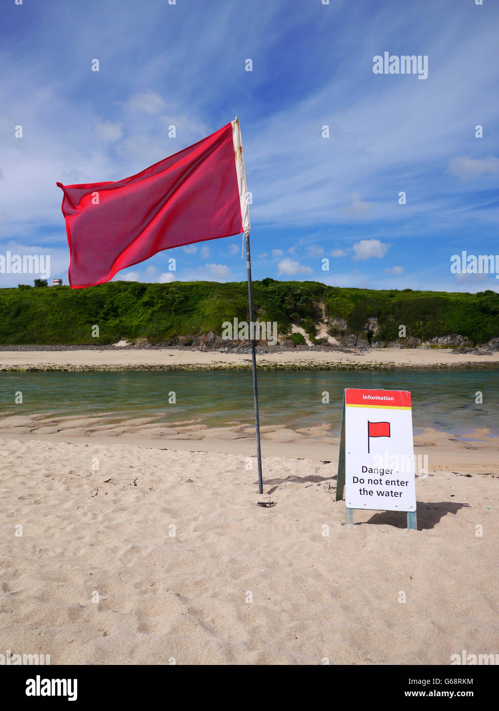 Red warning flag flying on beach Stock Photo - Alamy