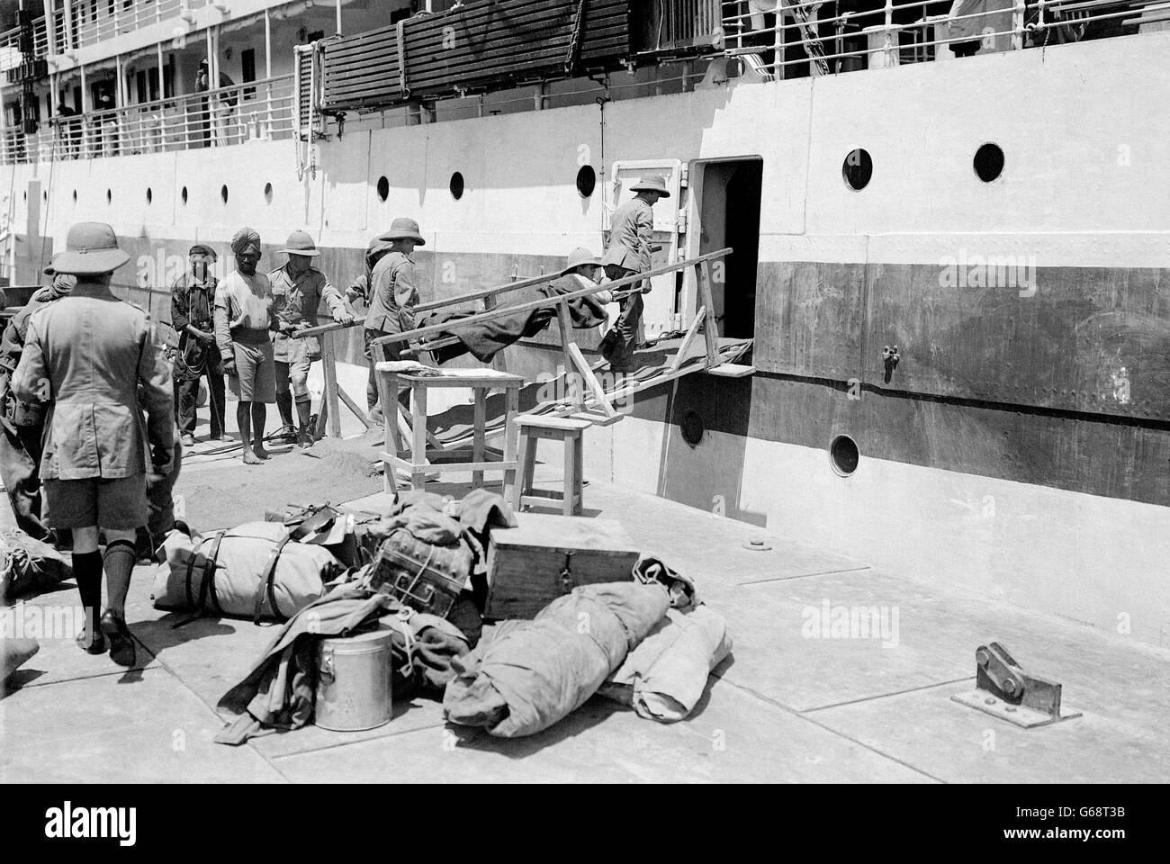 Wounded British soldiers being carried on to a hospital ship at Basra ...