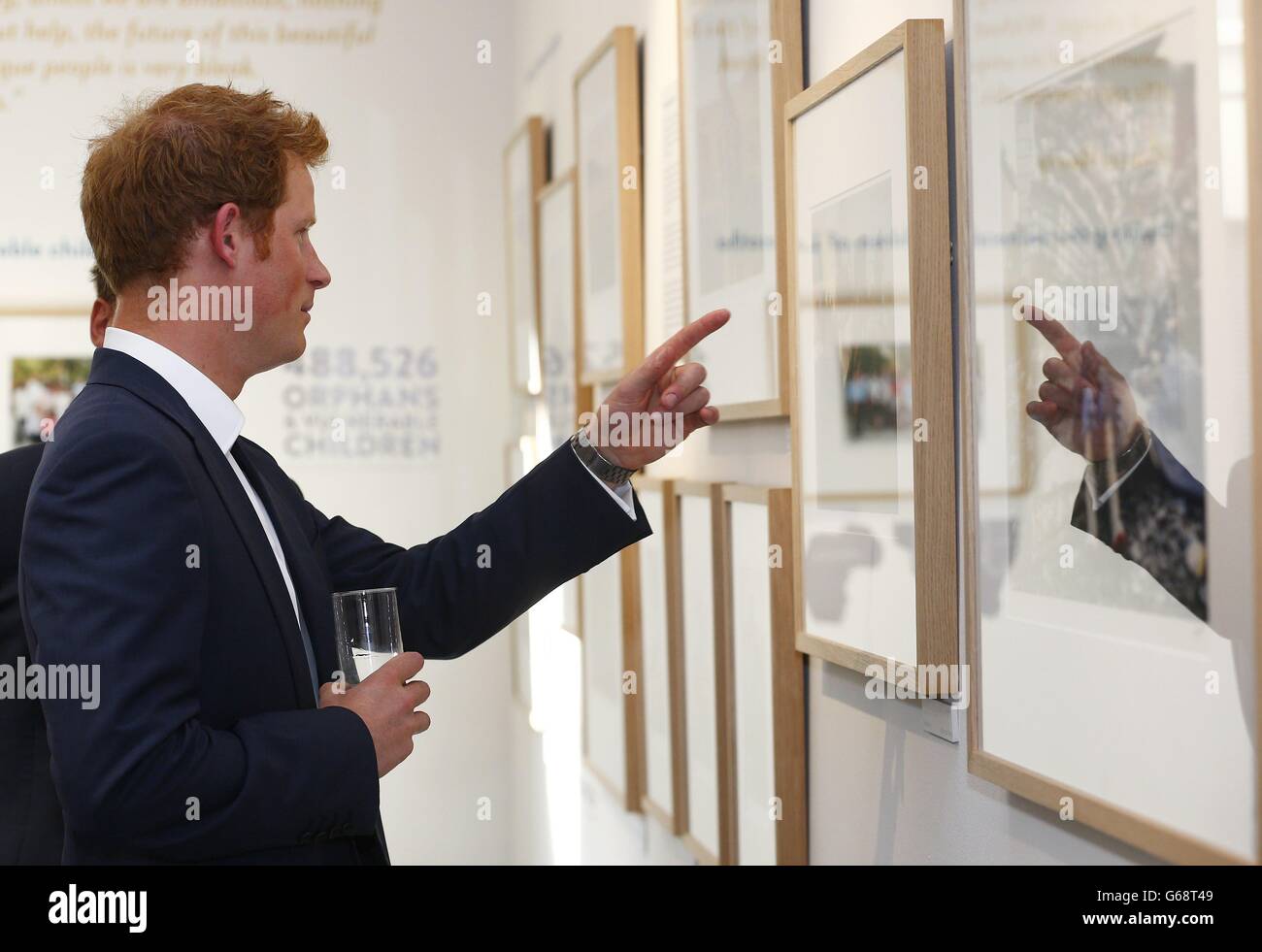 Prince Harry and photographer Chris Jackson view Jackson's photographs ...