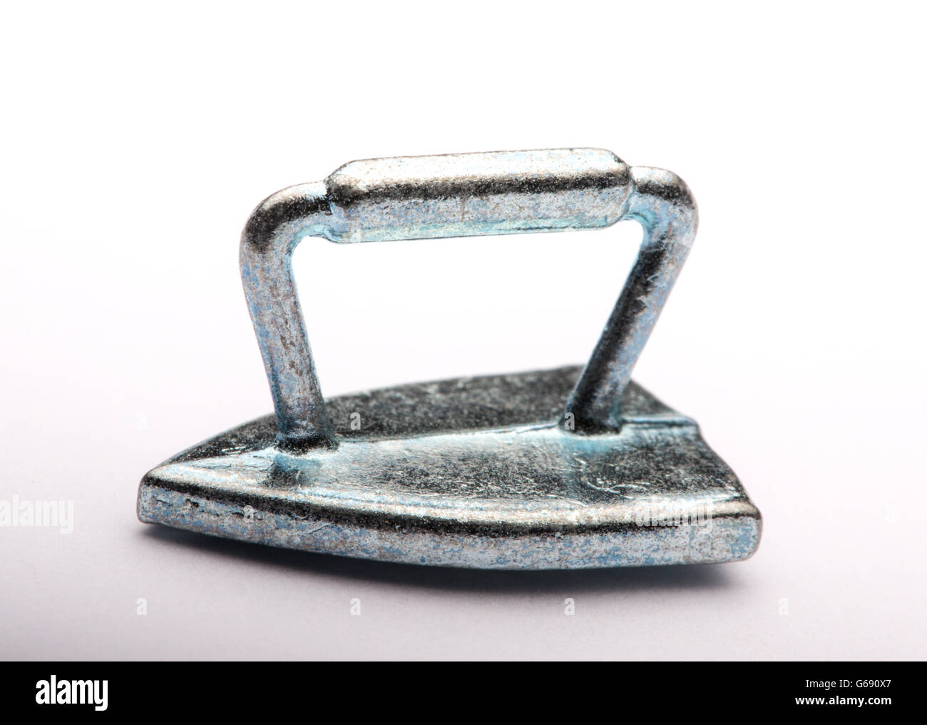 monopoly iron piece against a white background Stock Photo - Alamy