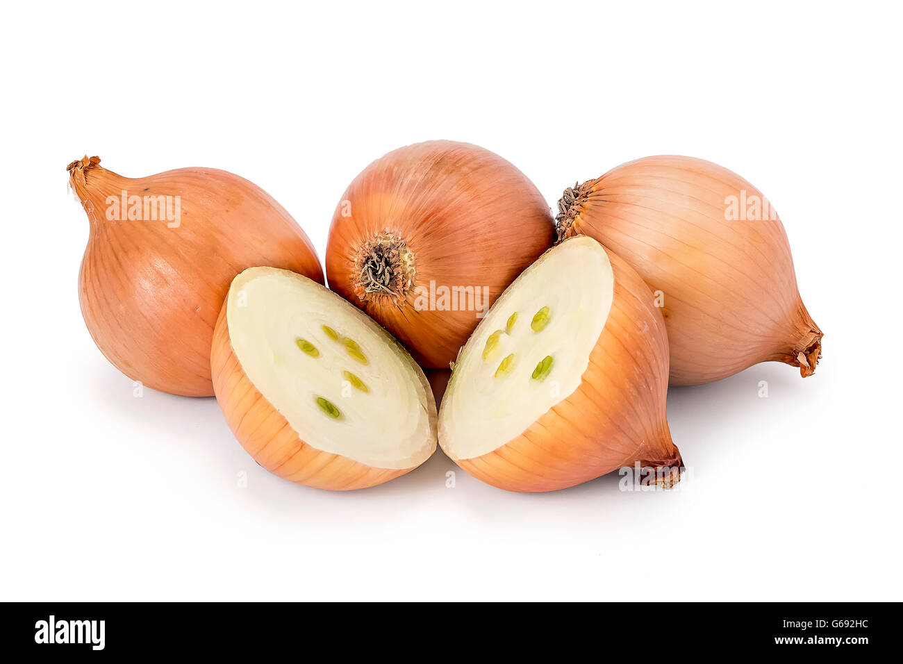 One cuted onion in front of three fresh onion bulbs isolated on white ...
