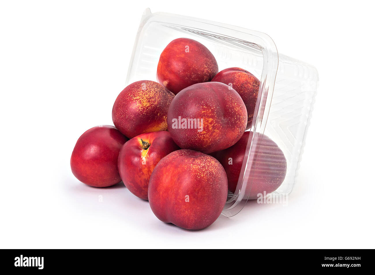 Box or punnet and spilled fresh ripe organic nectarines isolated on ...
