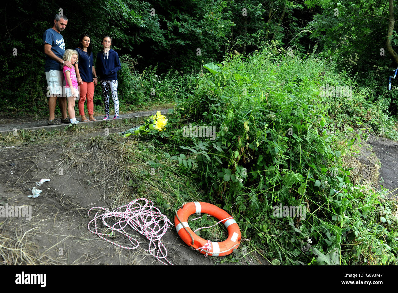 A family lays flowers by the river where Tonibeth Purvis, 15, from ...