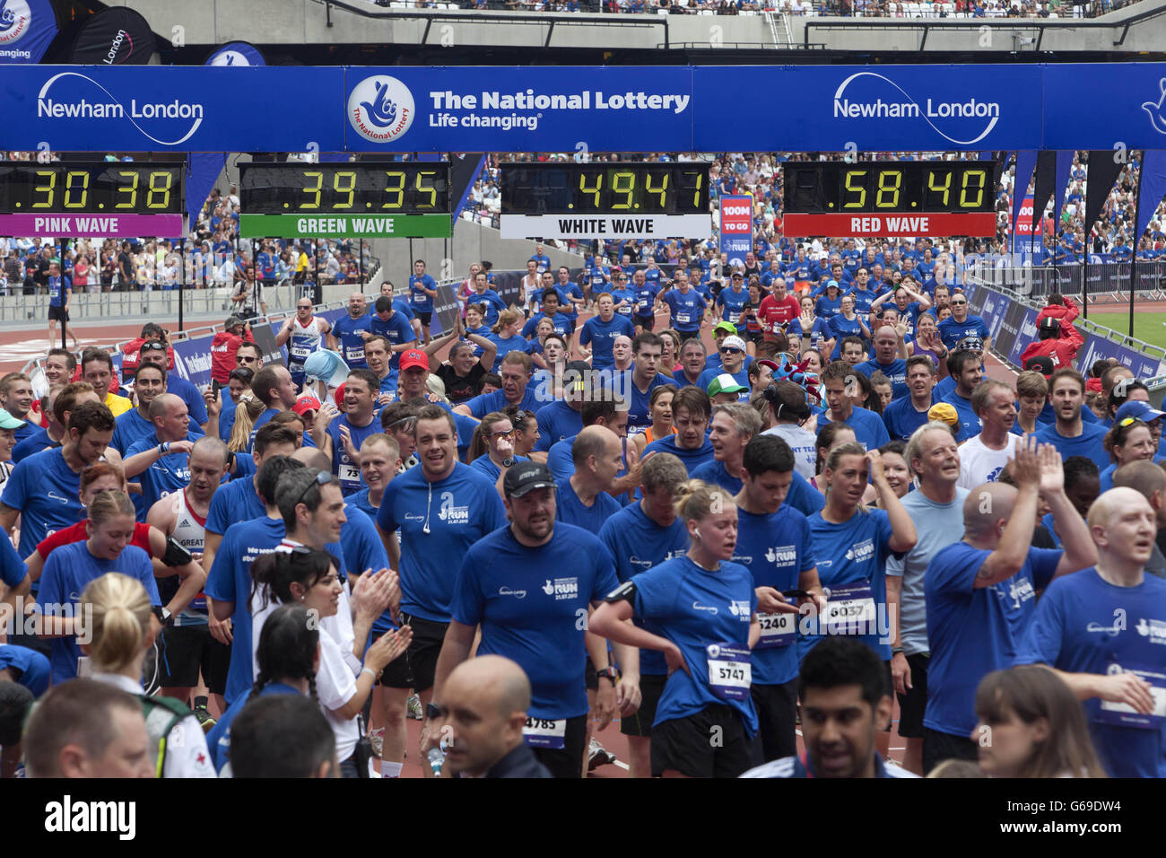 Runners cross the finish line in The National Lottery Anniversary Run ...