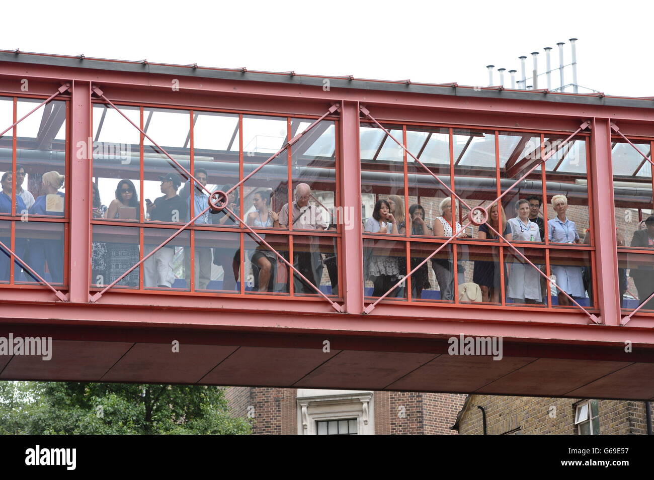 Hospital staff and patients look at the media outside the Lindo Wing of ...