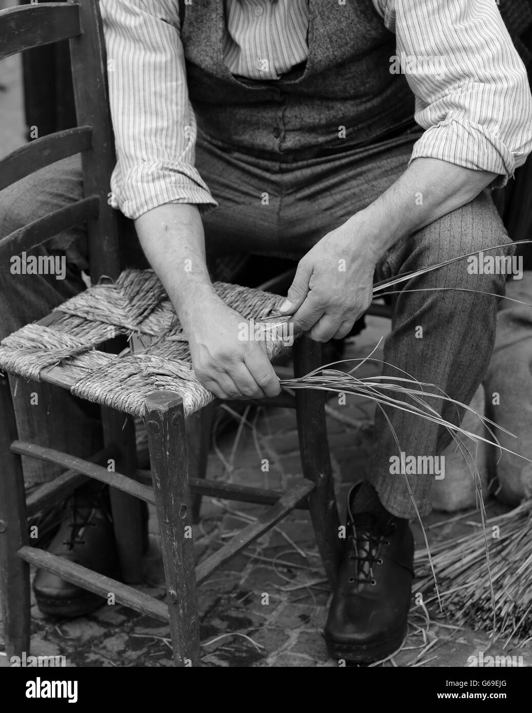 old man mender of chairs while repairing old chair Stock Photo - Alamy