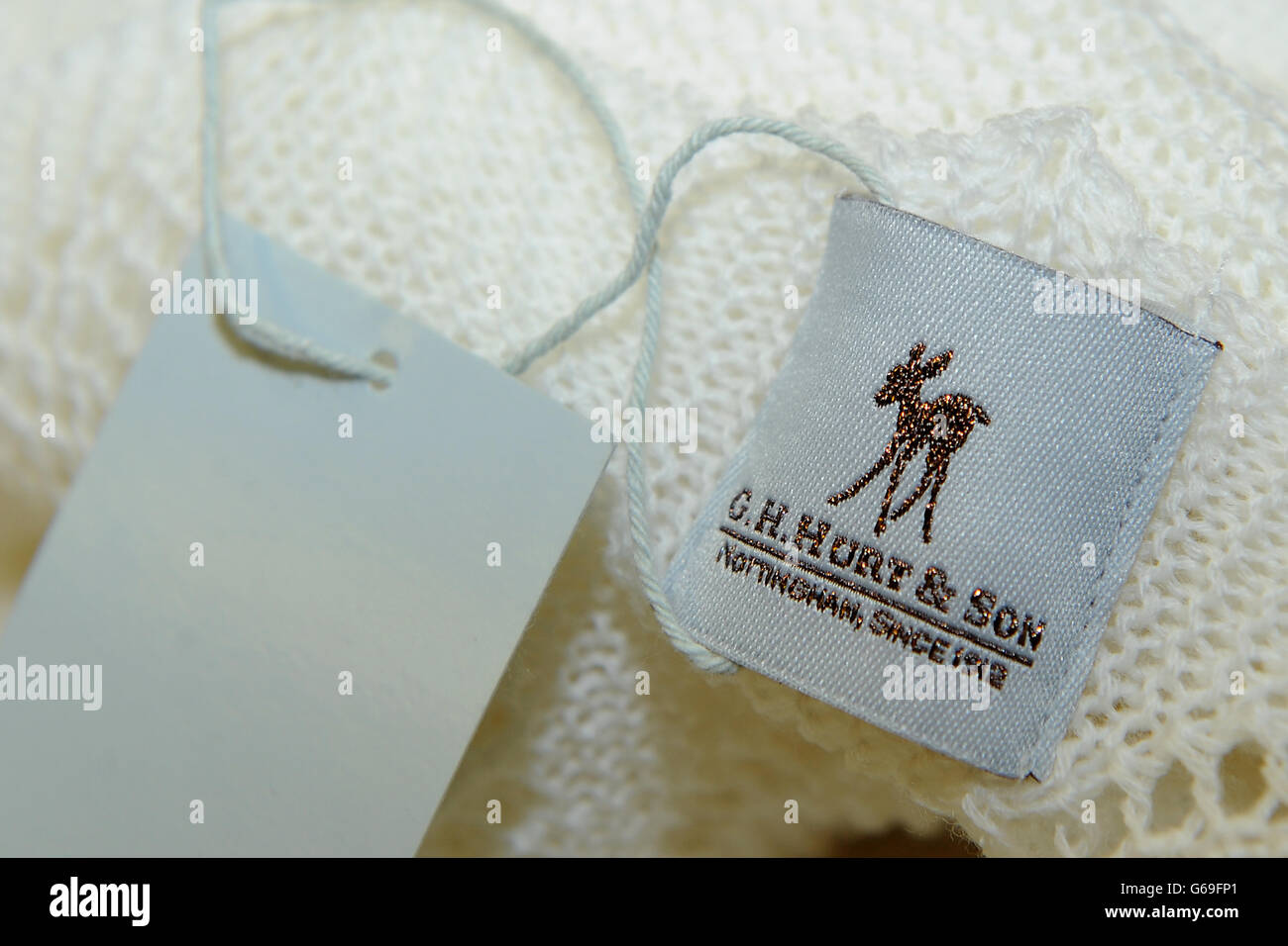 A label on a super-fine merino wool christening shawl as worn by Prince George of Cambridge ...