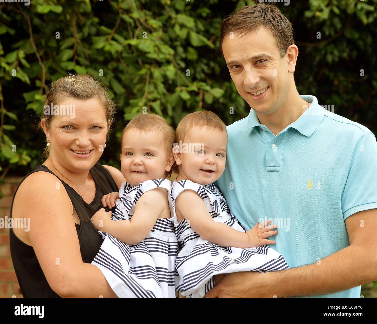 Angela and Daniel Formosa hold their daughters (left to right) Ruby and ...