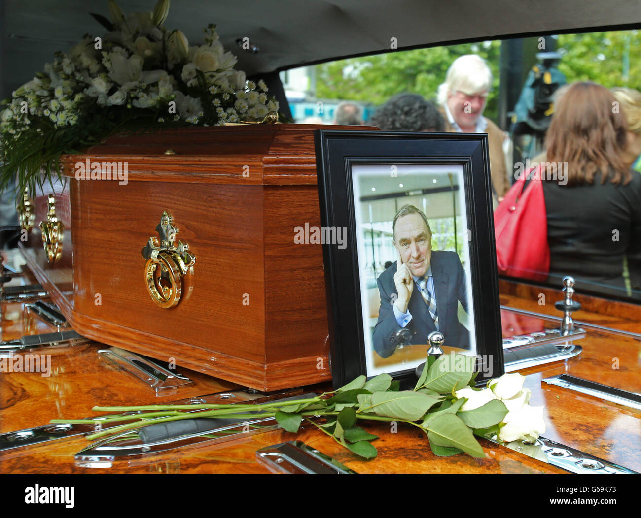 A portrait RTE presenter Colm Murray rests on his coffin at his funeral ...