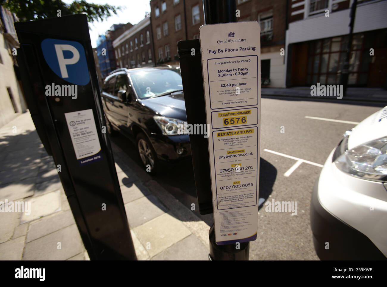 Parking stock. A parking sign and parking meter on the street in ...