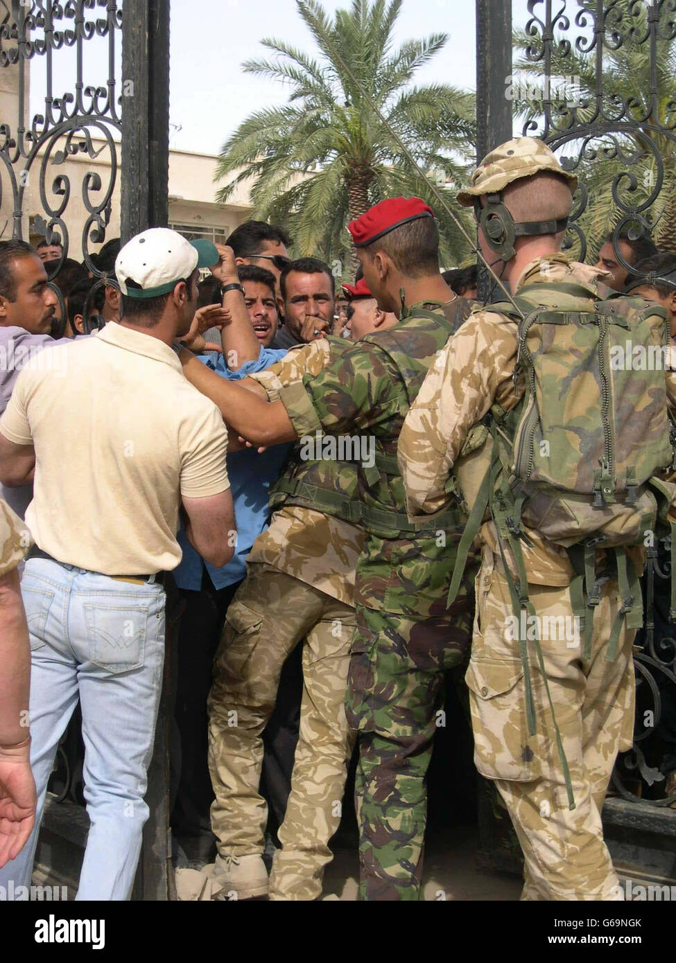 Soldiers at the main gate of Saddam Hussein's presidential palace in ...