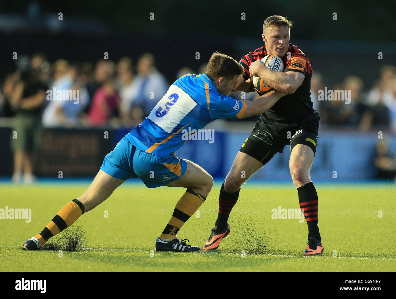 Saracens' Chris Ashton is held by Wasps' Sam Egerton during Group C ...