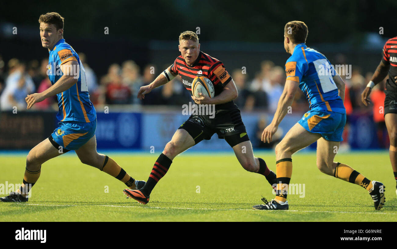 Saracens' Chris Ashton is held by Wasps' Sam Egerton (right) during ...