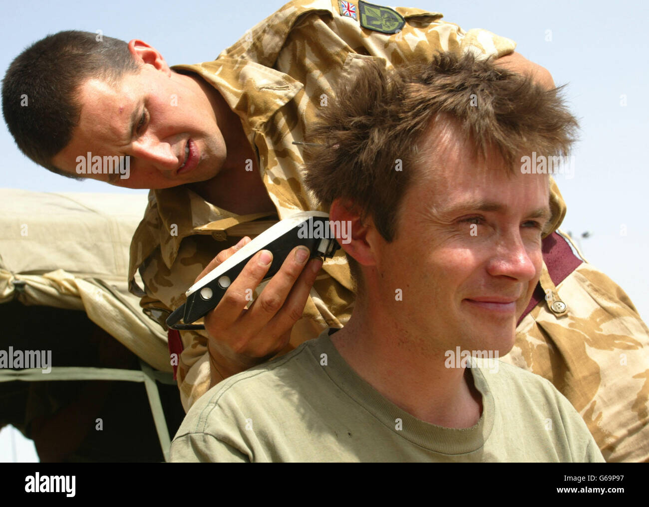 Troop gets first haircut in Iraq Stock Photo - Alamy