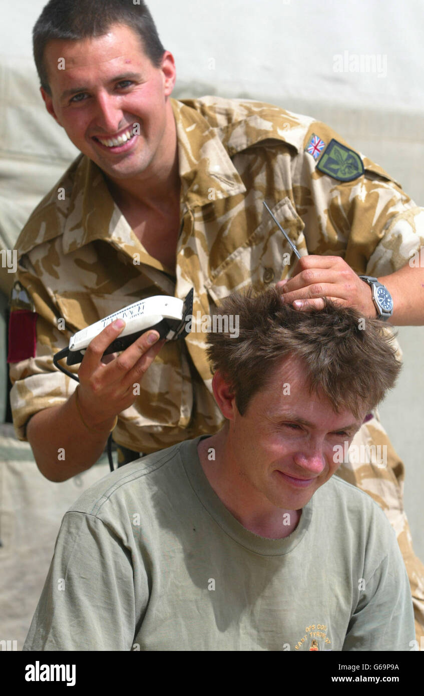 Troop gets first haircut in iraq hi-res stock photography and images ...