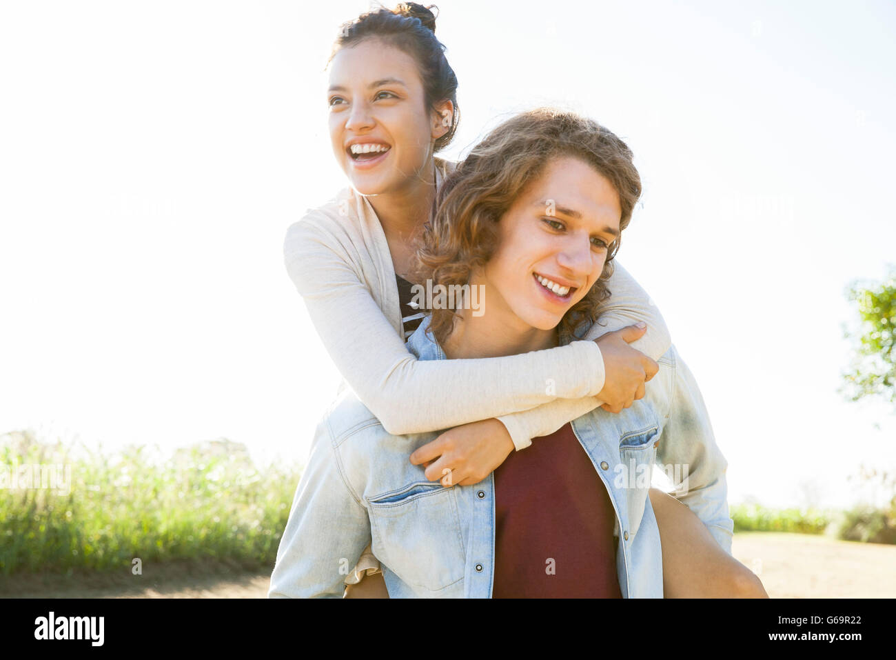 Man giving girlfriend piggyback ride Stock Photo - Alamy