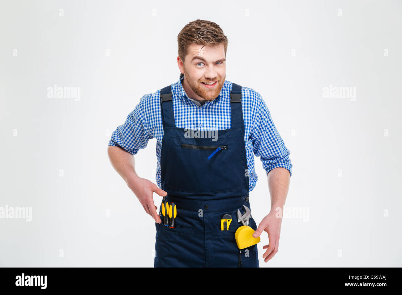 Funny male builder looking at camera isolated on a whtie background ...