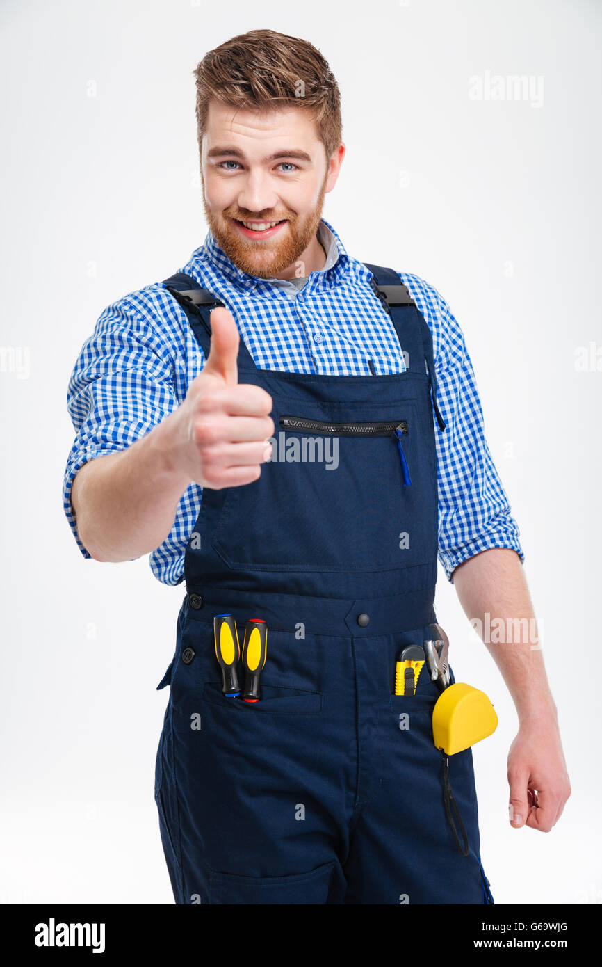 Happy male builder showing thumb up isolated on a white background ...