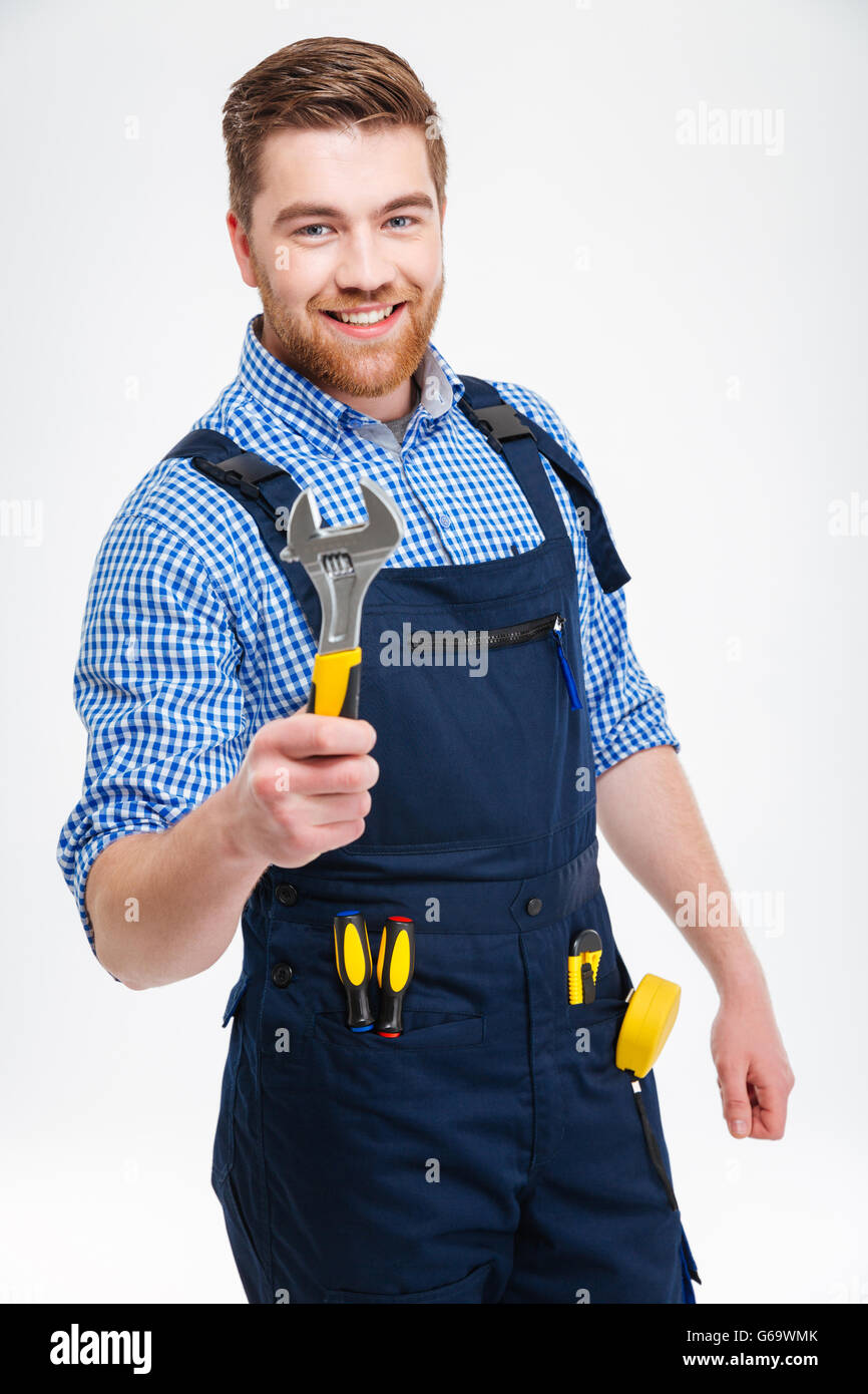 Smiling male builder holding wrench isolated on a white background ...
