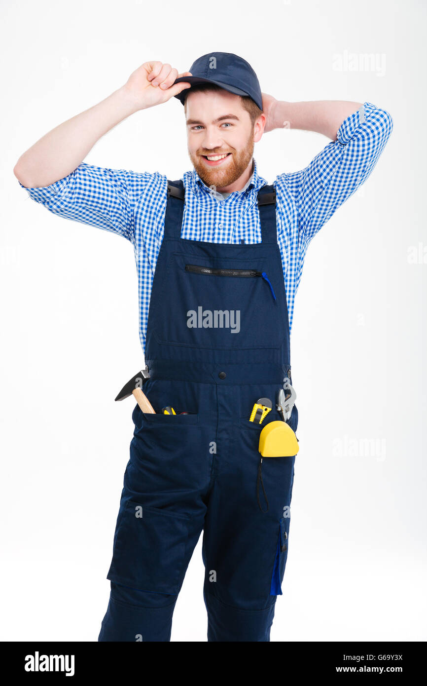 Cheerful bearded young handyman standing and smiling Stock Photo - Alamy